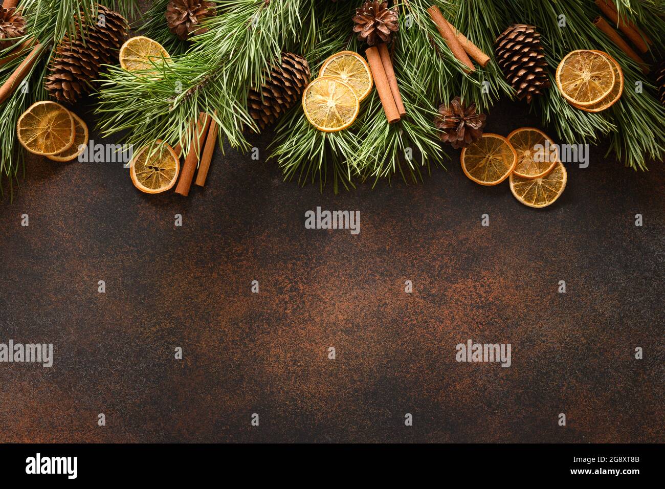 Christmas border with orange slice, aroma cinnamon, fir tree and cones ...