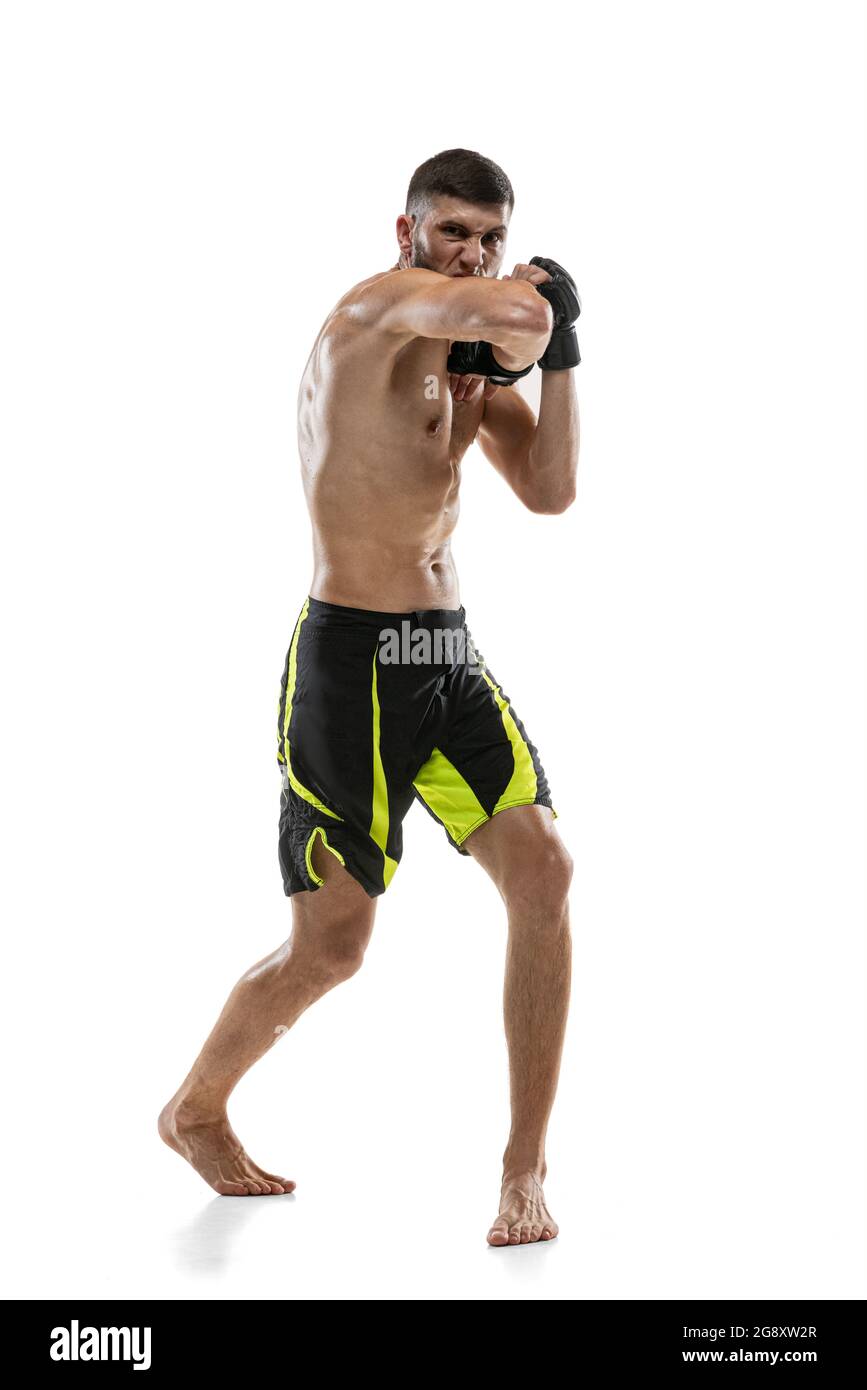 One man, professional male MMA boxer in motion isolated on white studio ...