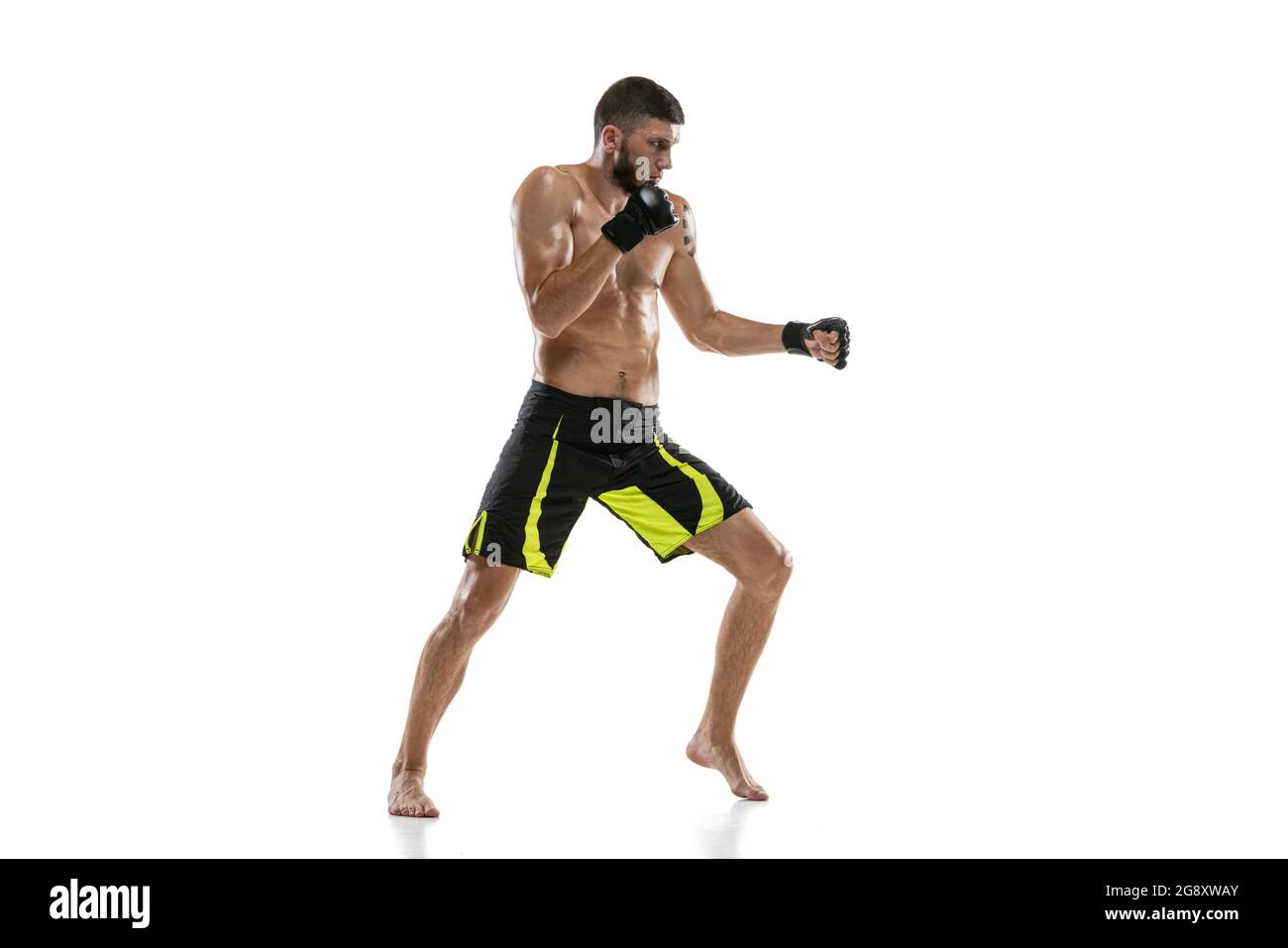 Professional male MMA boxer in motion isolated on white studio ...