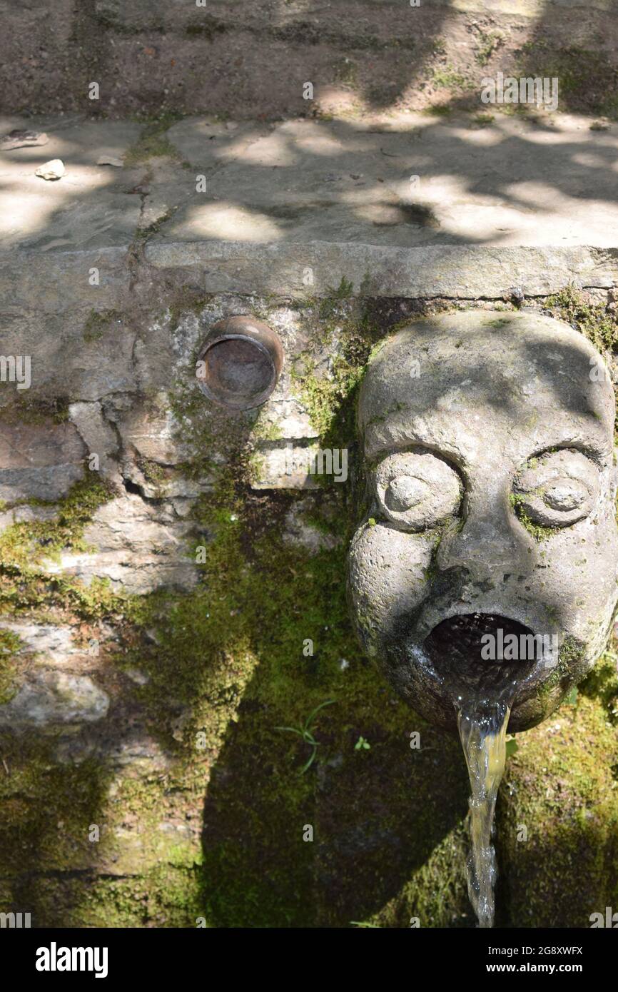 ancient water spitting stone face Stock Photo - Alamy