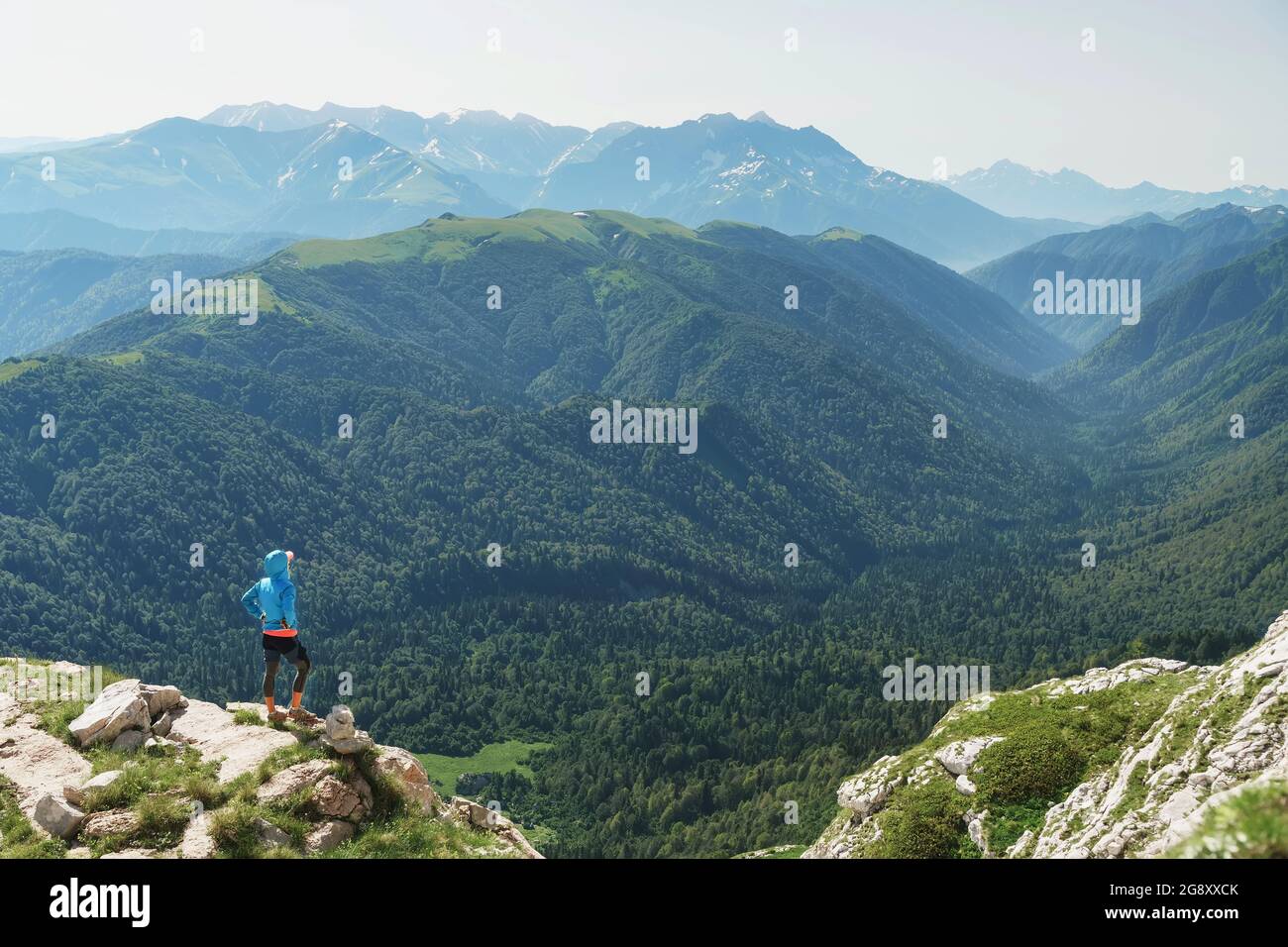A tourist on a rock looks back and looks into the valley of the canyon ...