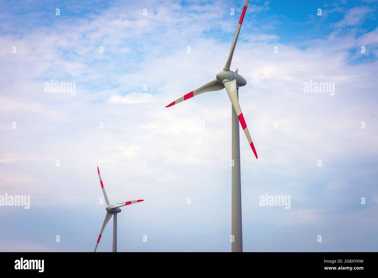 Two Wind turbines with blue sky background summer day.An ...