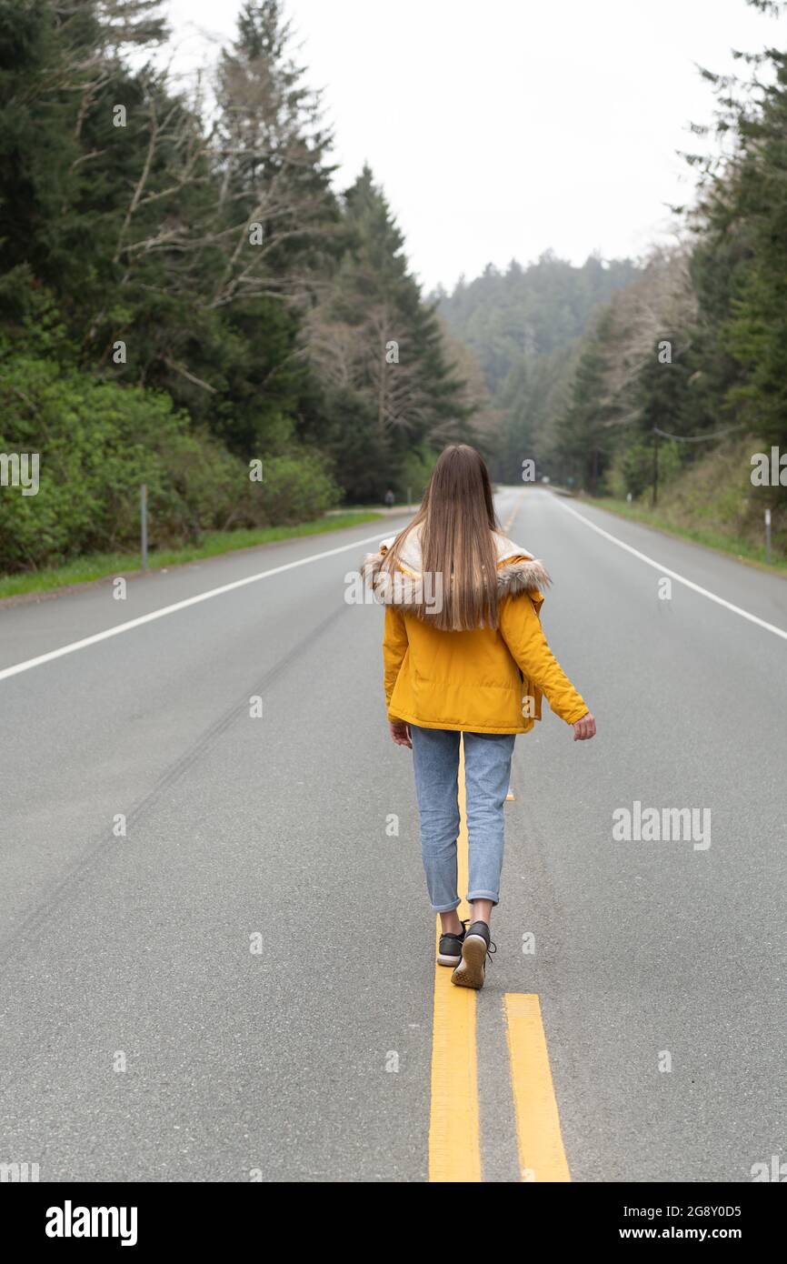 future concept. highway road among forest with walking girl Stock Photo ...