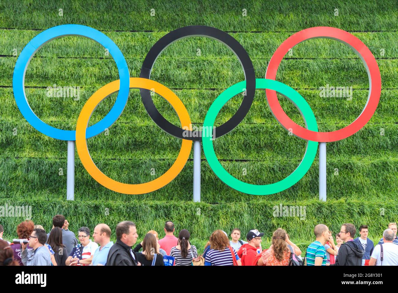 People gather in front of the Olympic rings, iconic logo of the Olympic ...