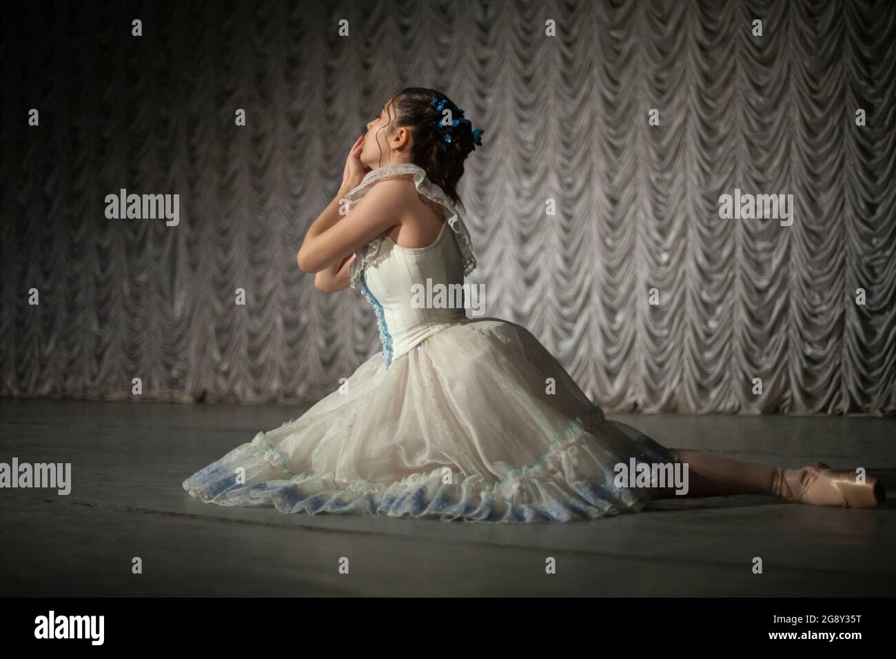 The ballerina dances on stage. The girl performs with a dance. A lesson ...