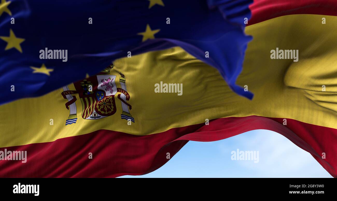 The national flag of Spain waving in the wind together with the ...