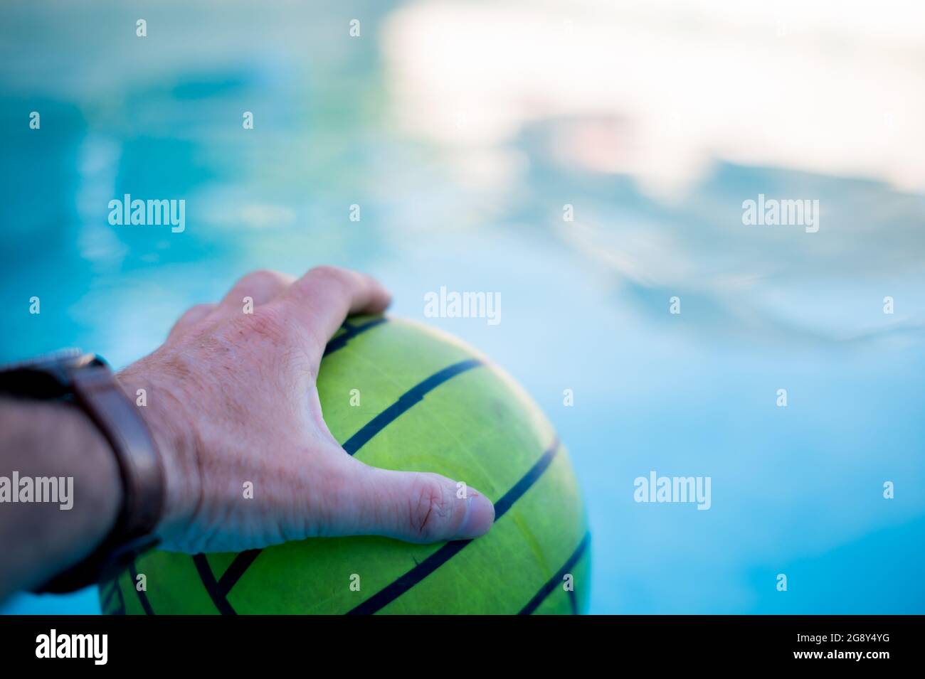 close-up view of a hand grasping a rubber ball in the water Stock Photo ...