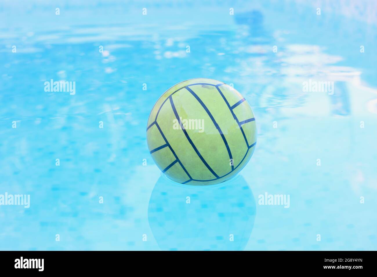 green rubber ball floating in a pool of turquoise water Stock Photo - Alamy