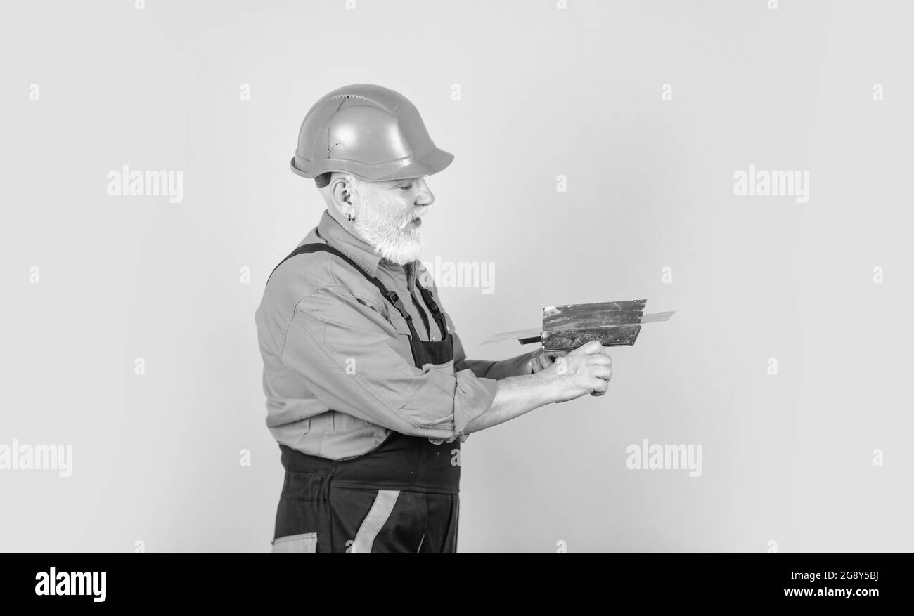 He needs little break. Plasterer in working uniform plastering. man ...