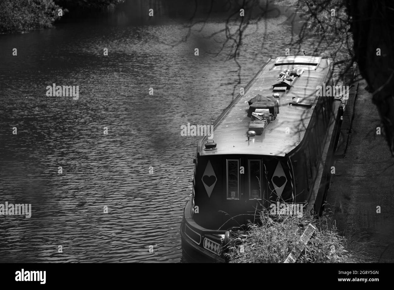 A narrowboat moored by the old boathouse on the beautiful Basingstoke ...