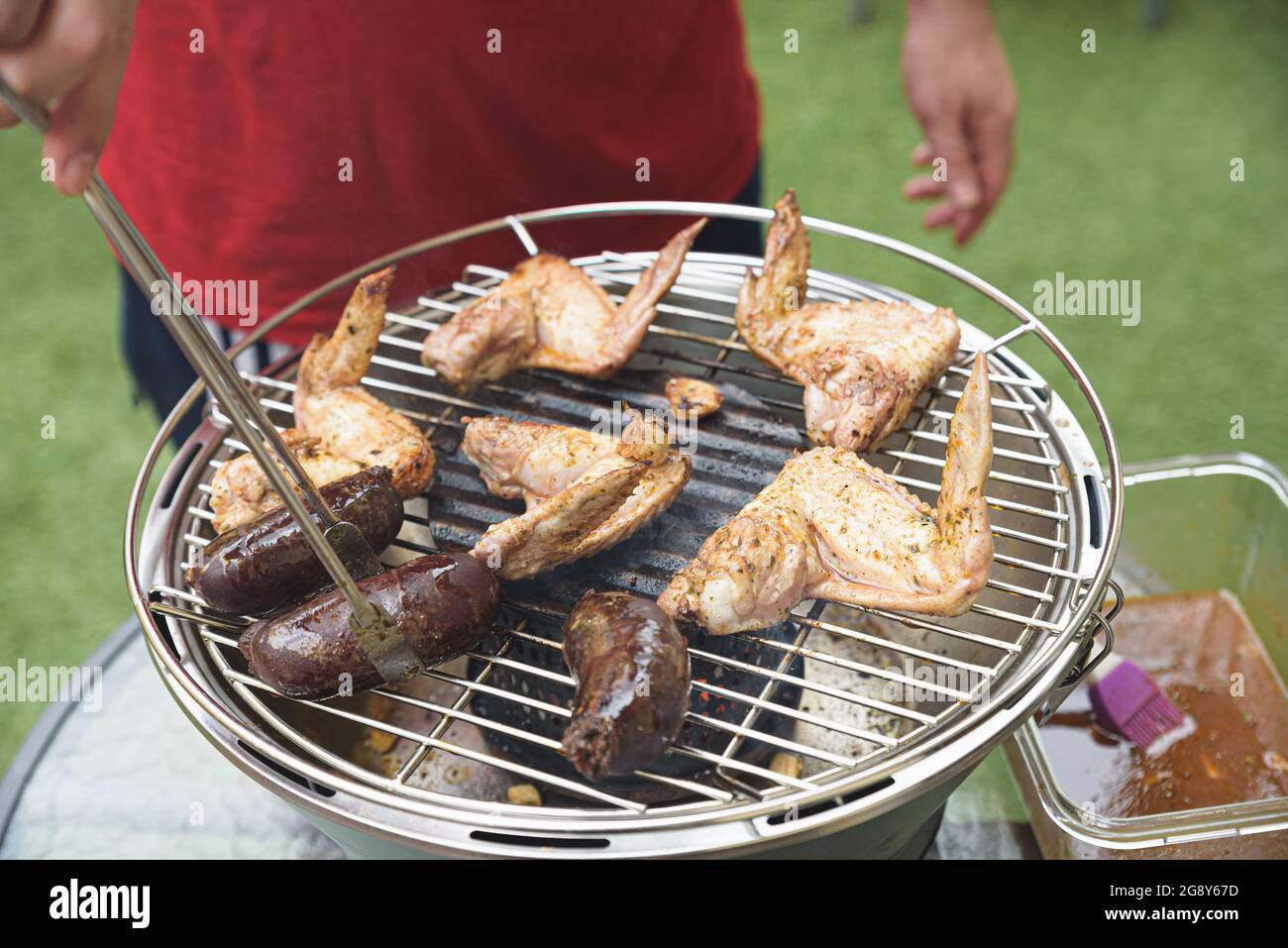 Man Barbequing In A Garden Stock Photo - Alamy