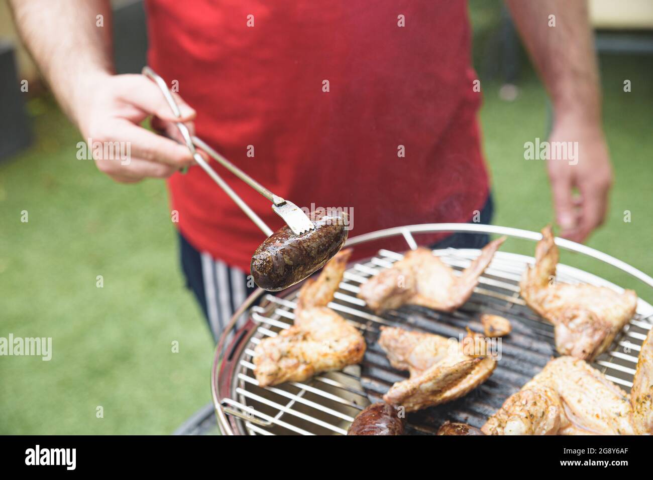 Man Barbequing In A Garden Stock Photo - Alamy