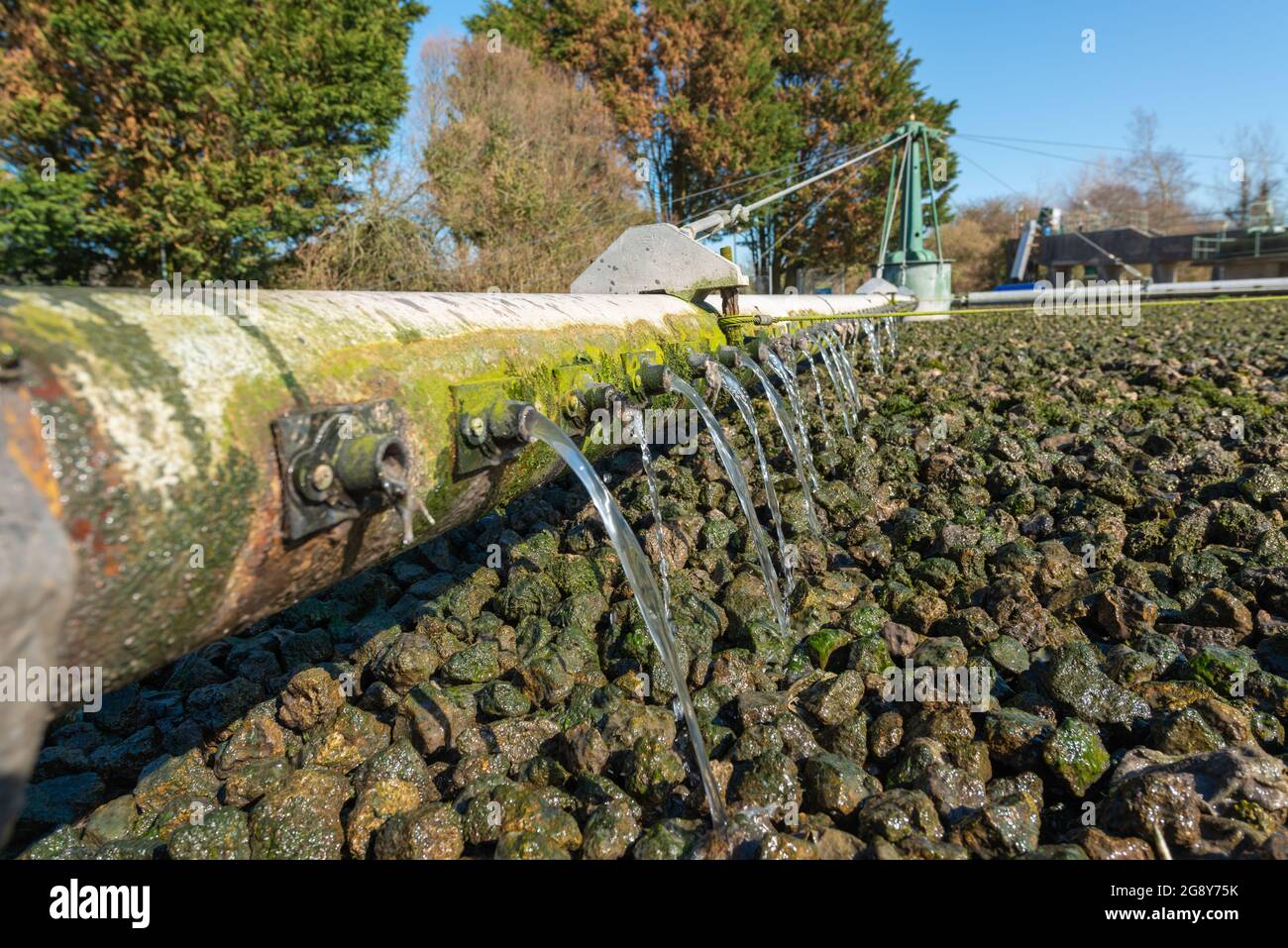 Rotary arm discharging waste water on filter bed, sewage treatment ...