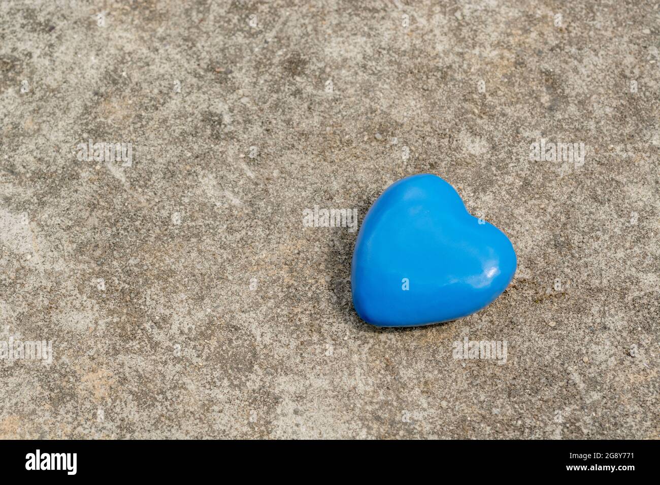 Blue heart on weathered cement surface for Blue Monday, feeling gloomy ...