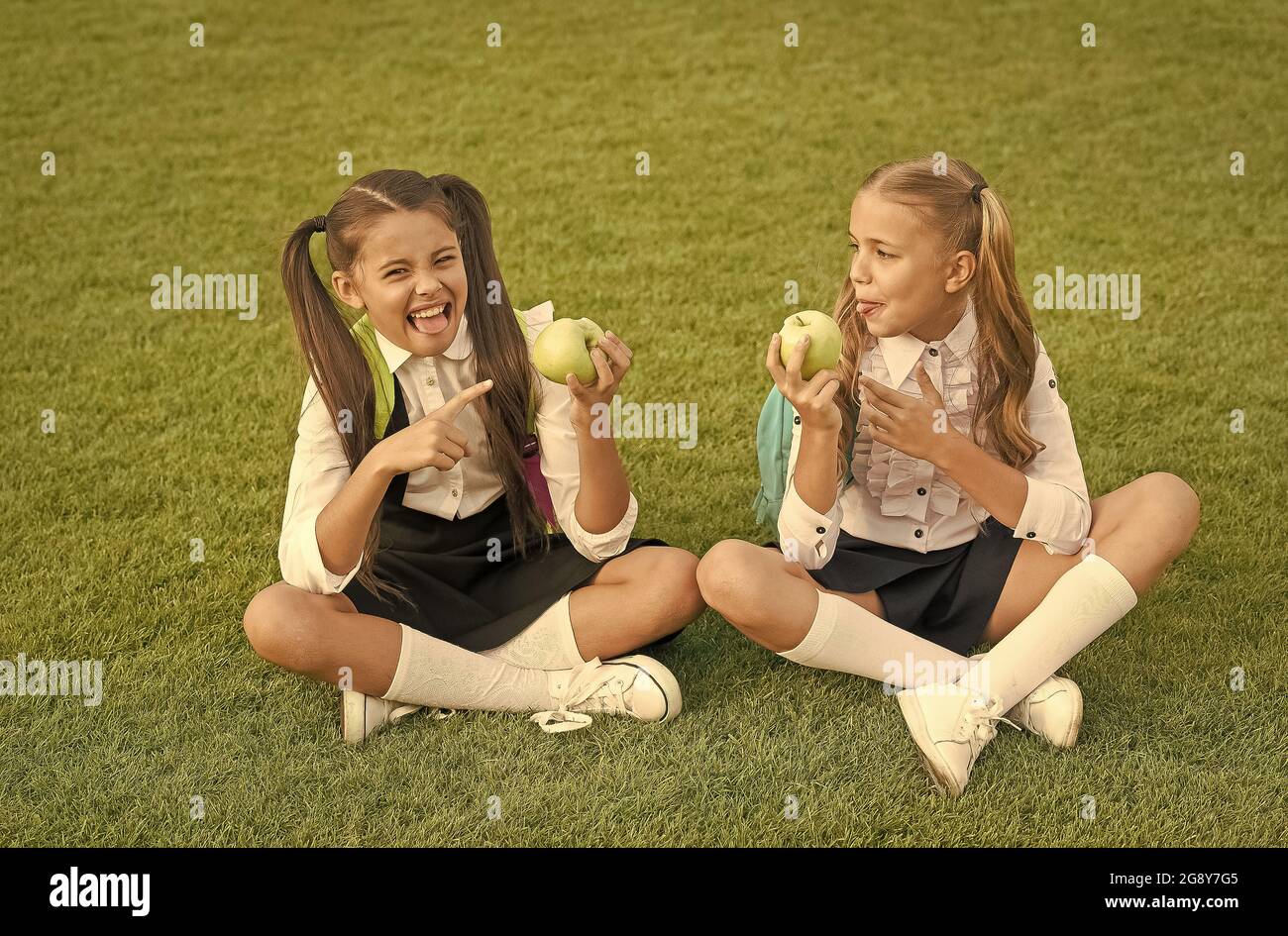 Having taste of lemon. Little girl point at sour apple fruit. Fruit ...