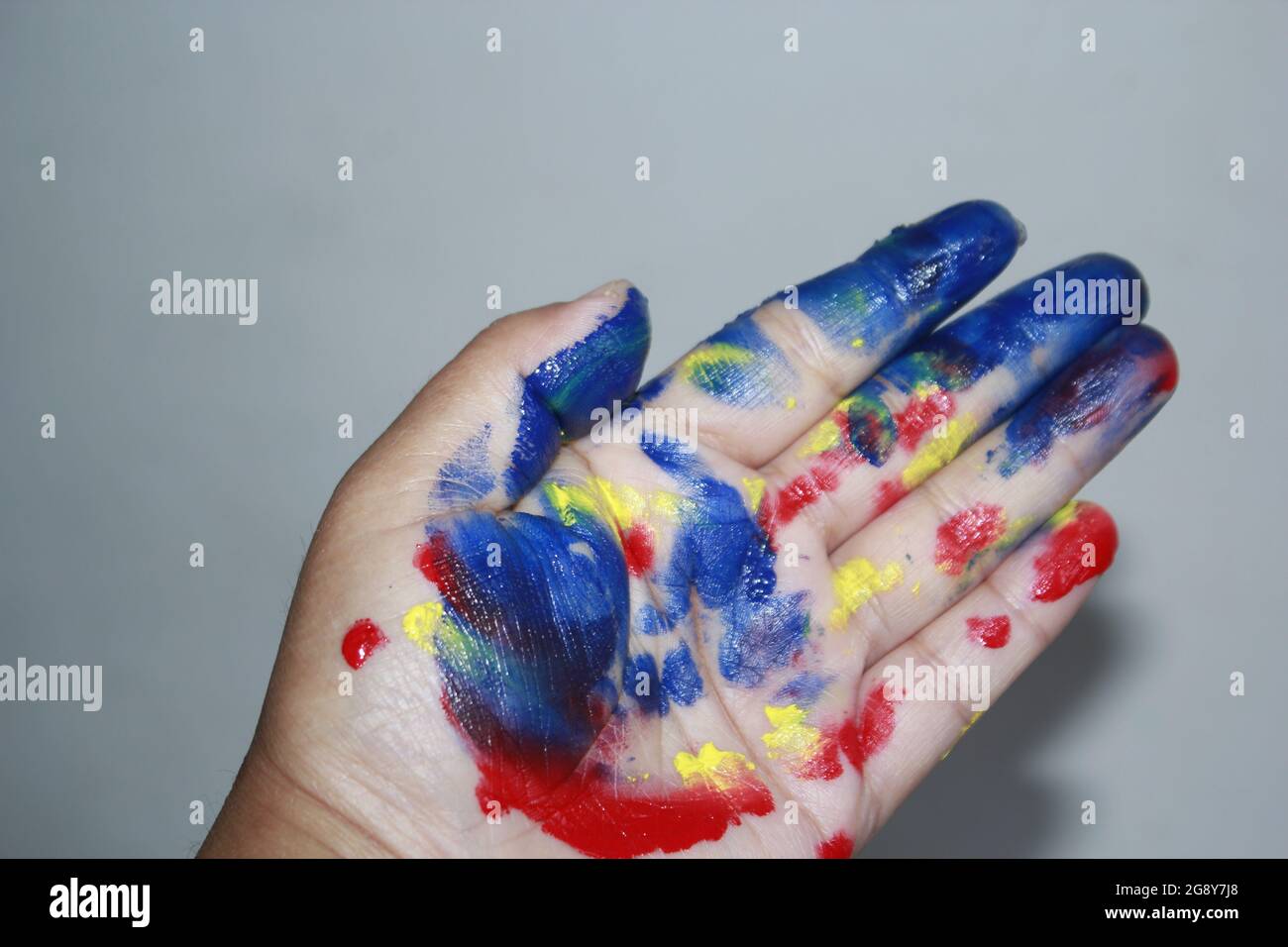 Holidays Colorful a lady's hand on white background Stock Photo - Alamy