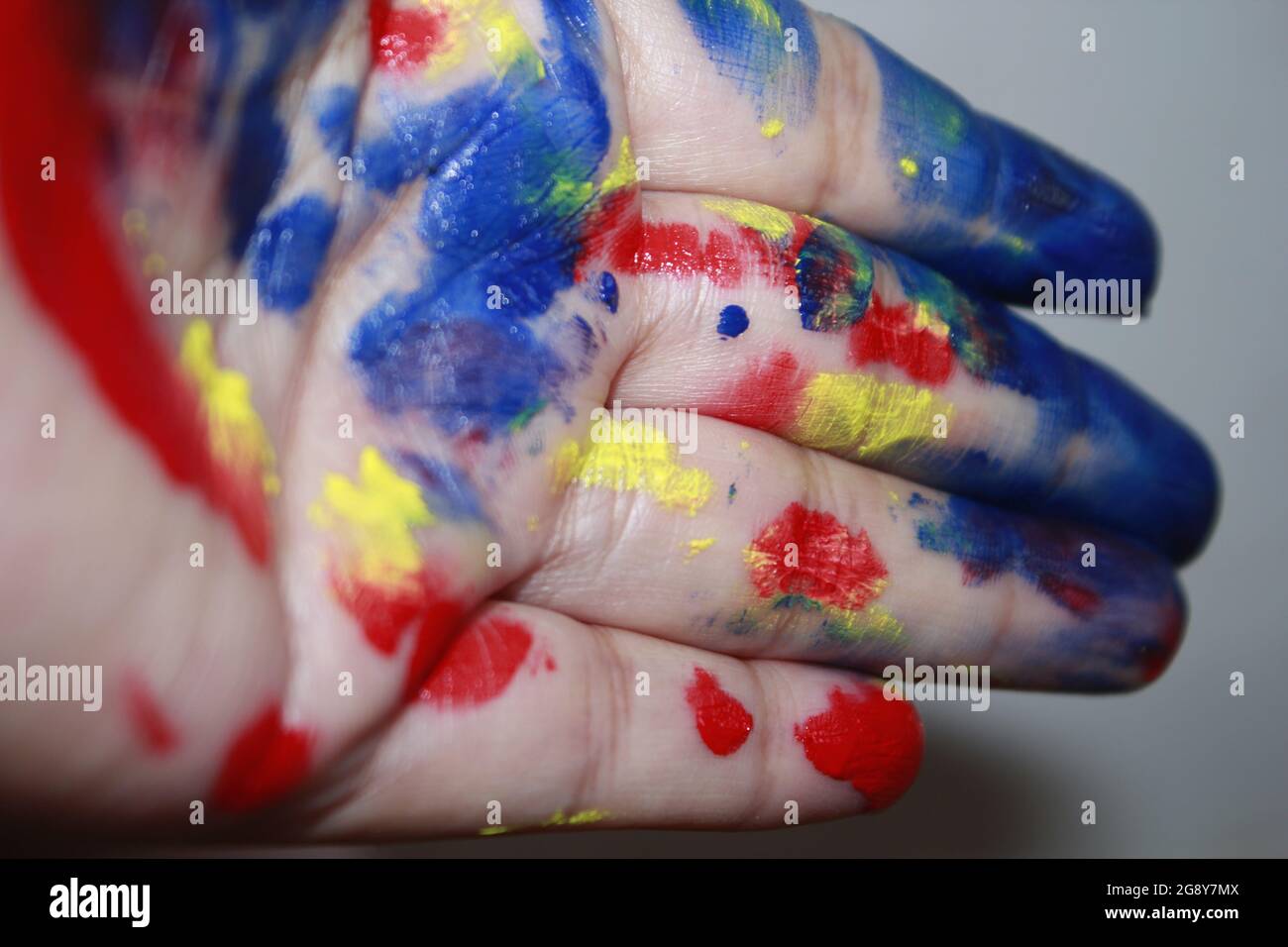 Holidays Colorful a lady's hand on white background Stock Photo - Alamy