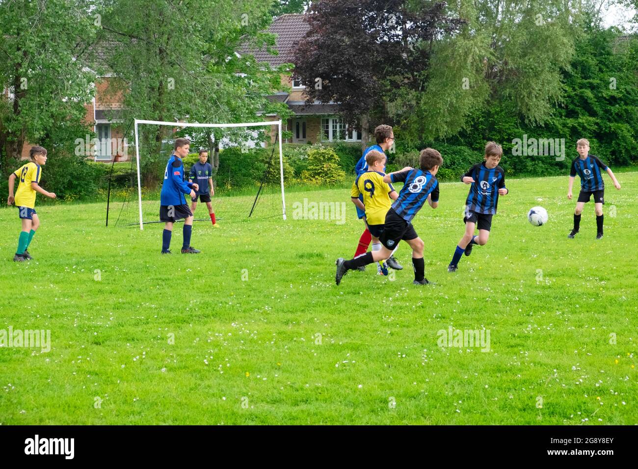 Kids playing football in football kit hi-res stock photography and ...