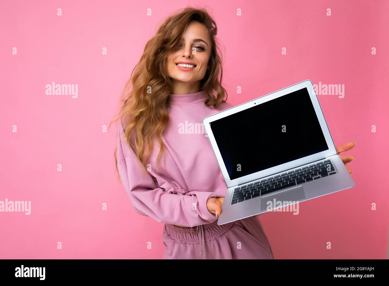 Photo of beautiful smiling happy blond curly young woman lookind at ...