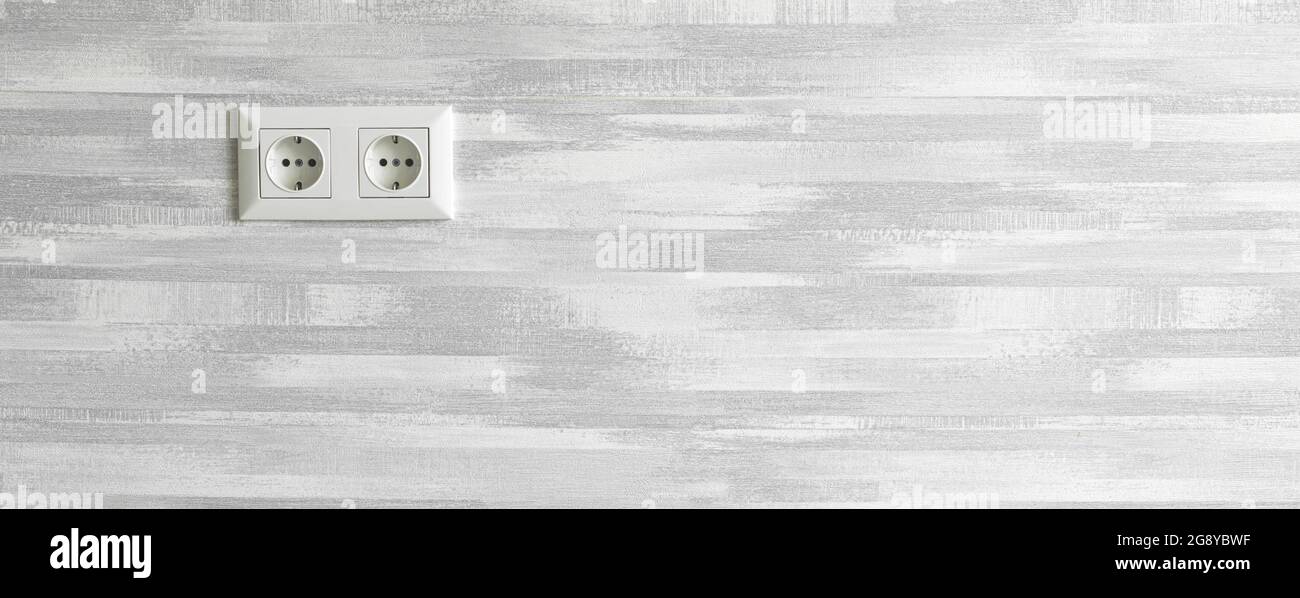 Banner with power outlet on the gray wall in modern home interior ...