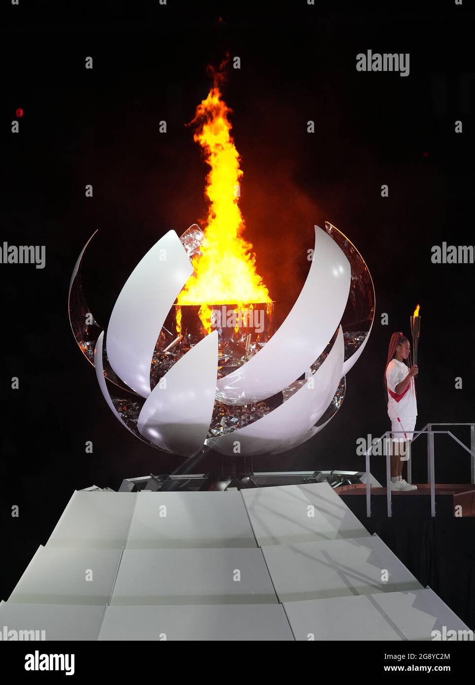 Naomi Osaka lights the Olympic flame during the opening ceremony of the ...