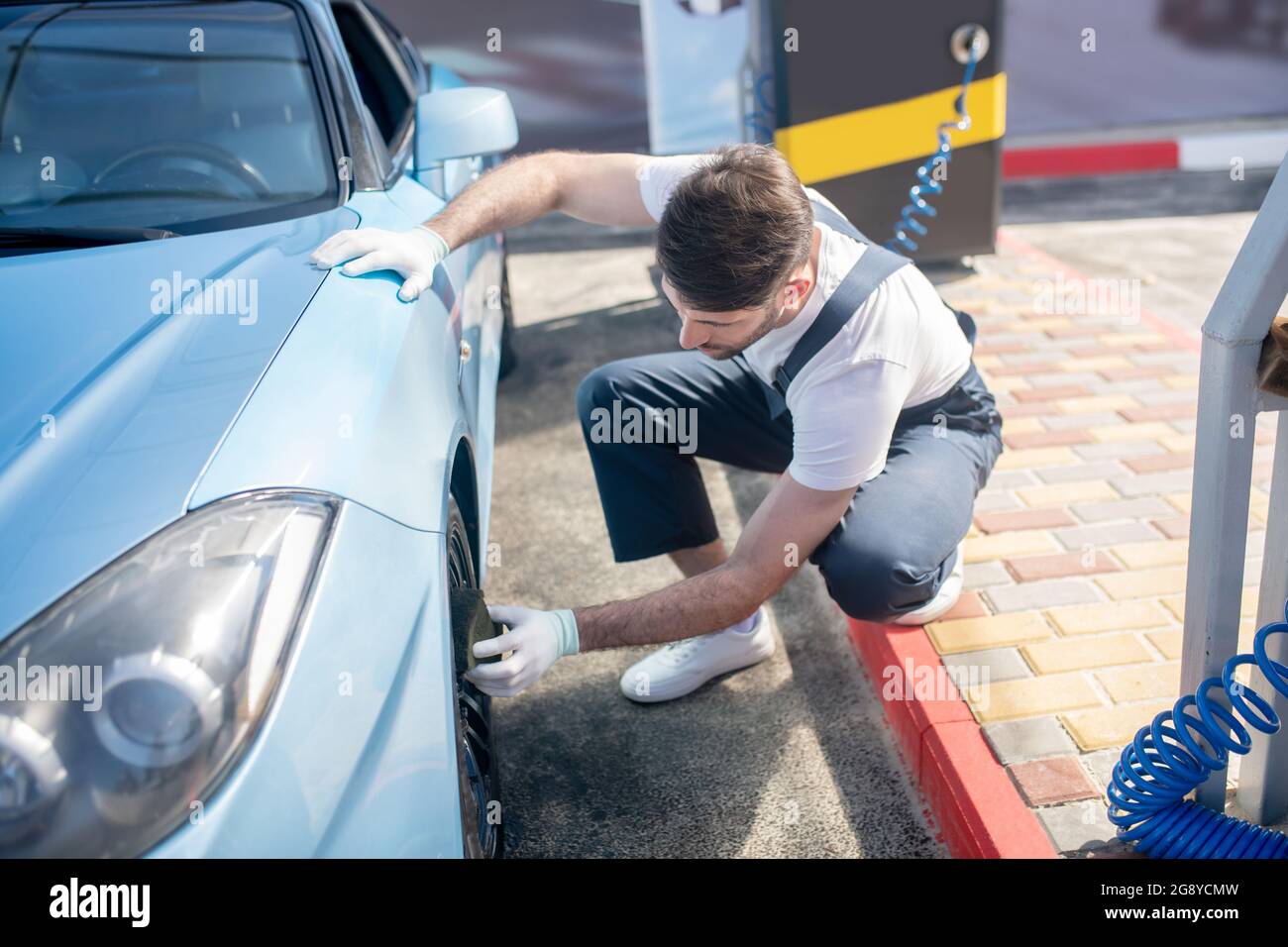 Man screwing cap of protective wheel nut Stock Photo - Alamy
