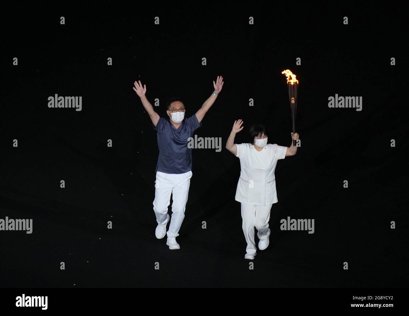 Tokyo, Japan. 23rd July, 2021. Torch bearer runs with the Olympic flame ...