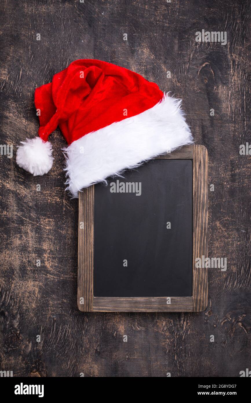 Christmas dark background with Santa hat Stock Photo - Alamy