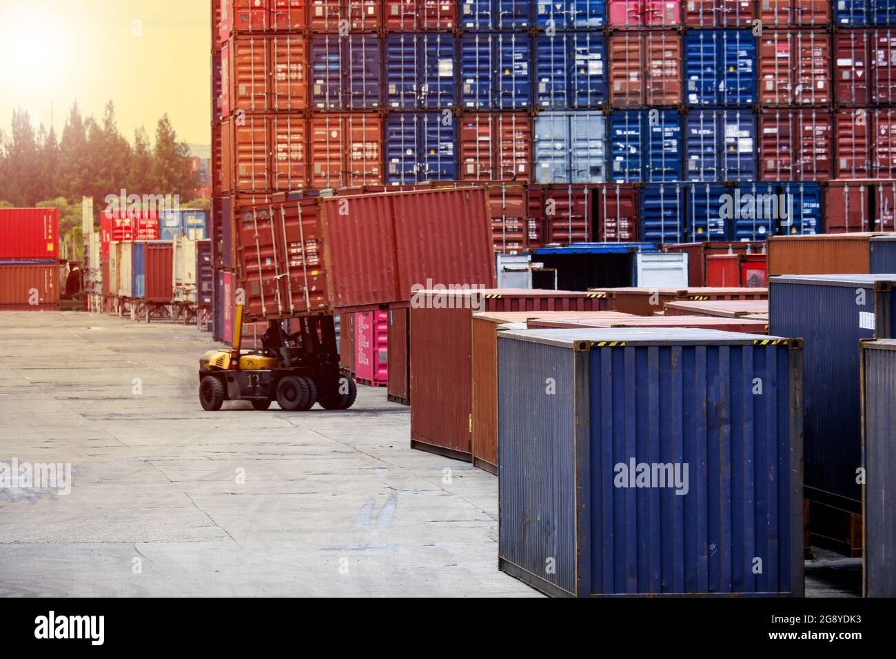 Forklift truck lifting cargo container in shipping yard or dock yard ...