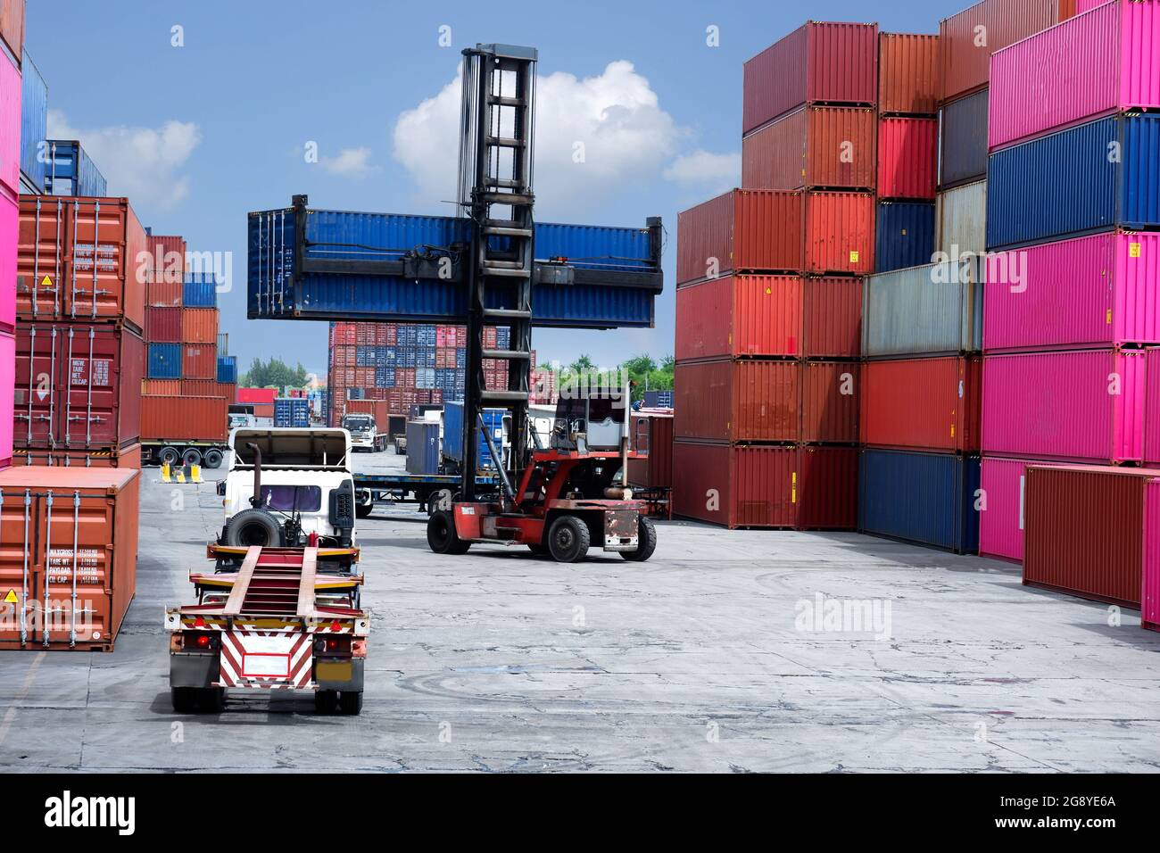 Forklift truck lifting cargo container in shipping yard or dock yard ...