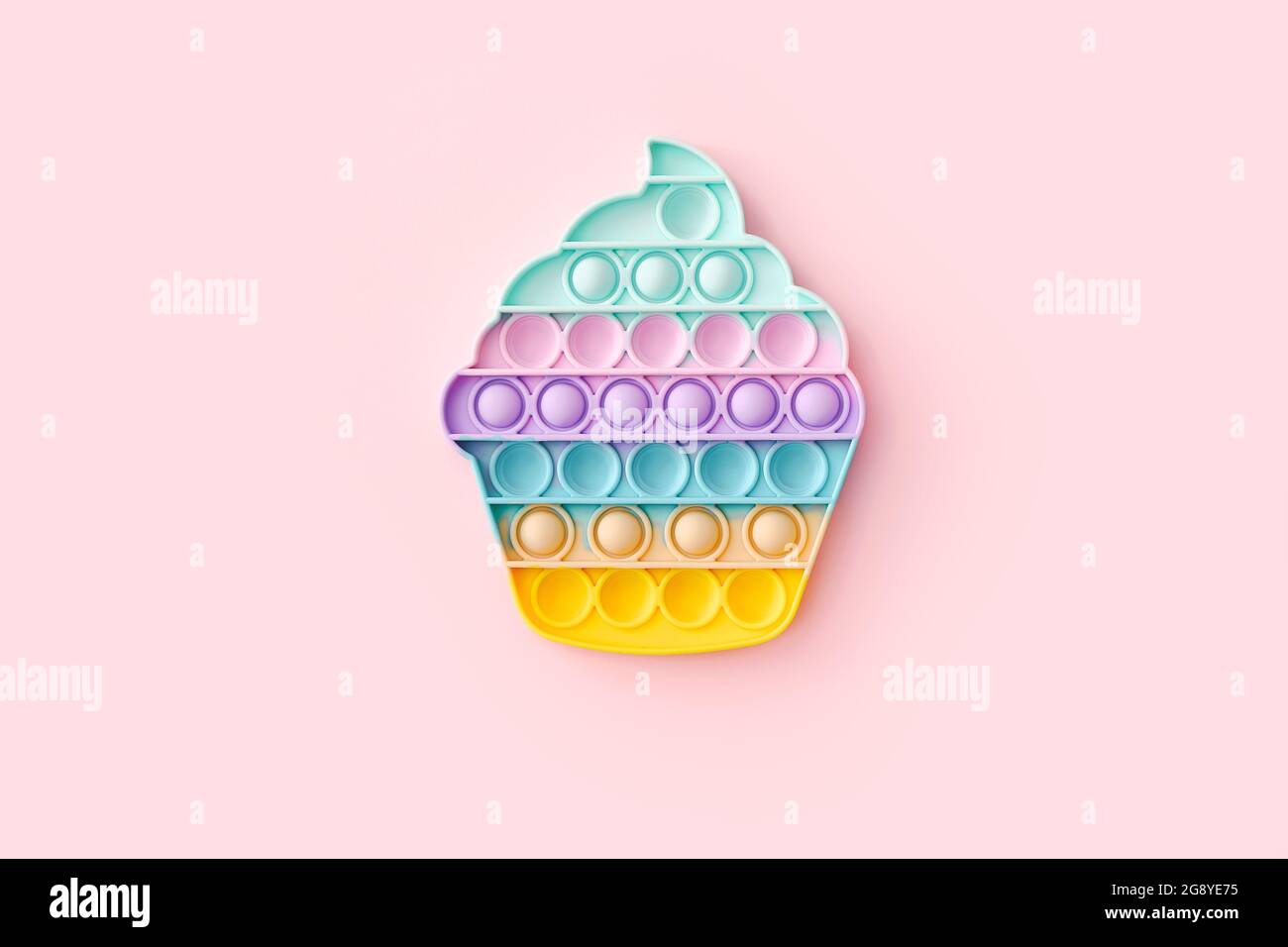 Popit toy in the form of a cupcake on a pink background, top view Stock ...