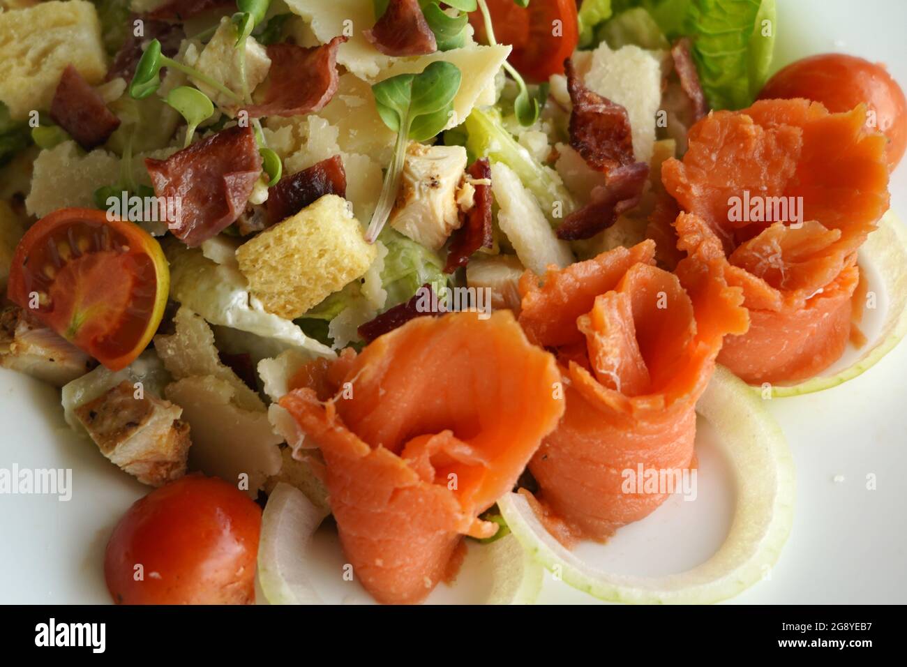 Closeup of a delicious salmon salad with croutons and vegetables in a ...