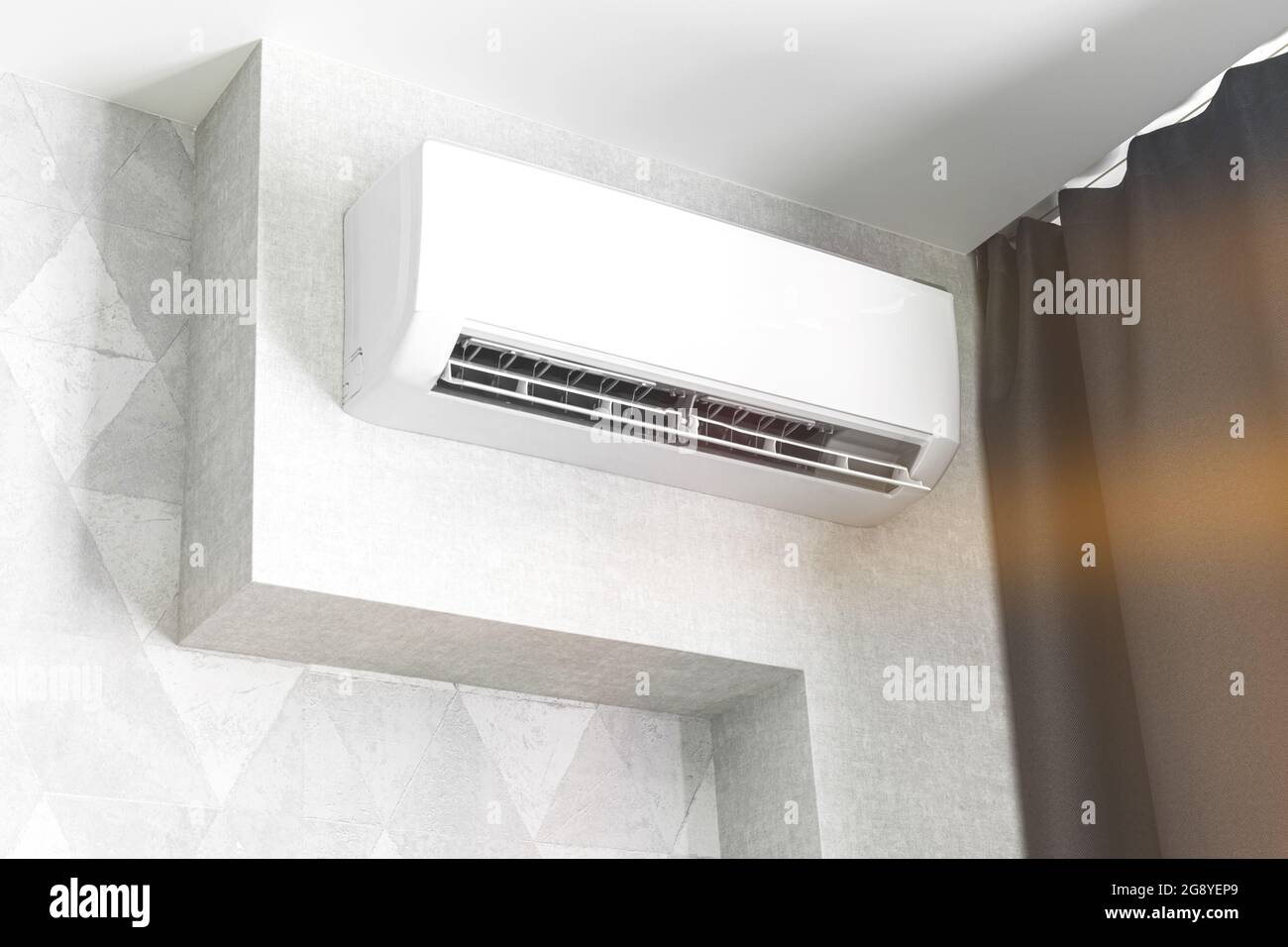 Air conditioner system on white wall living room interior, modern ...