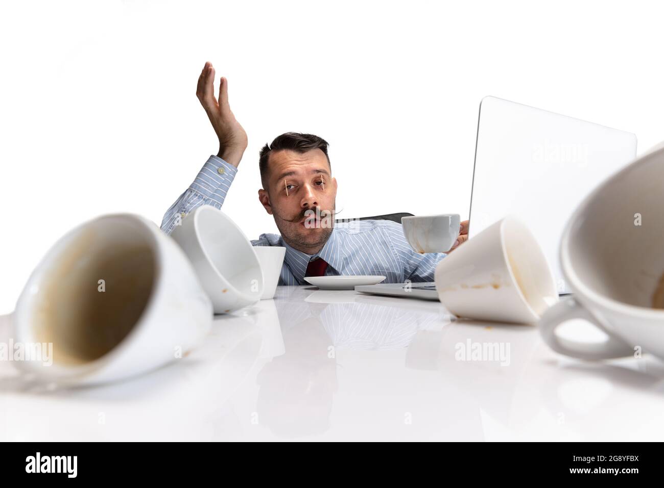 Portrait of young sleepy Caucasian man, office worker sitting at table ...