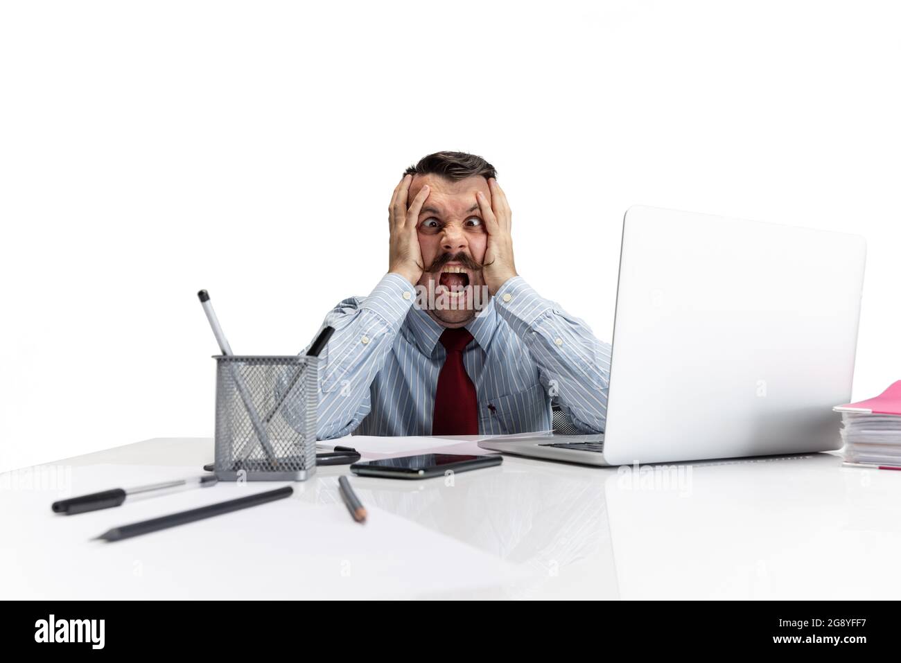 One screaming angry young Caucasian man, office worker, manager sitting ...