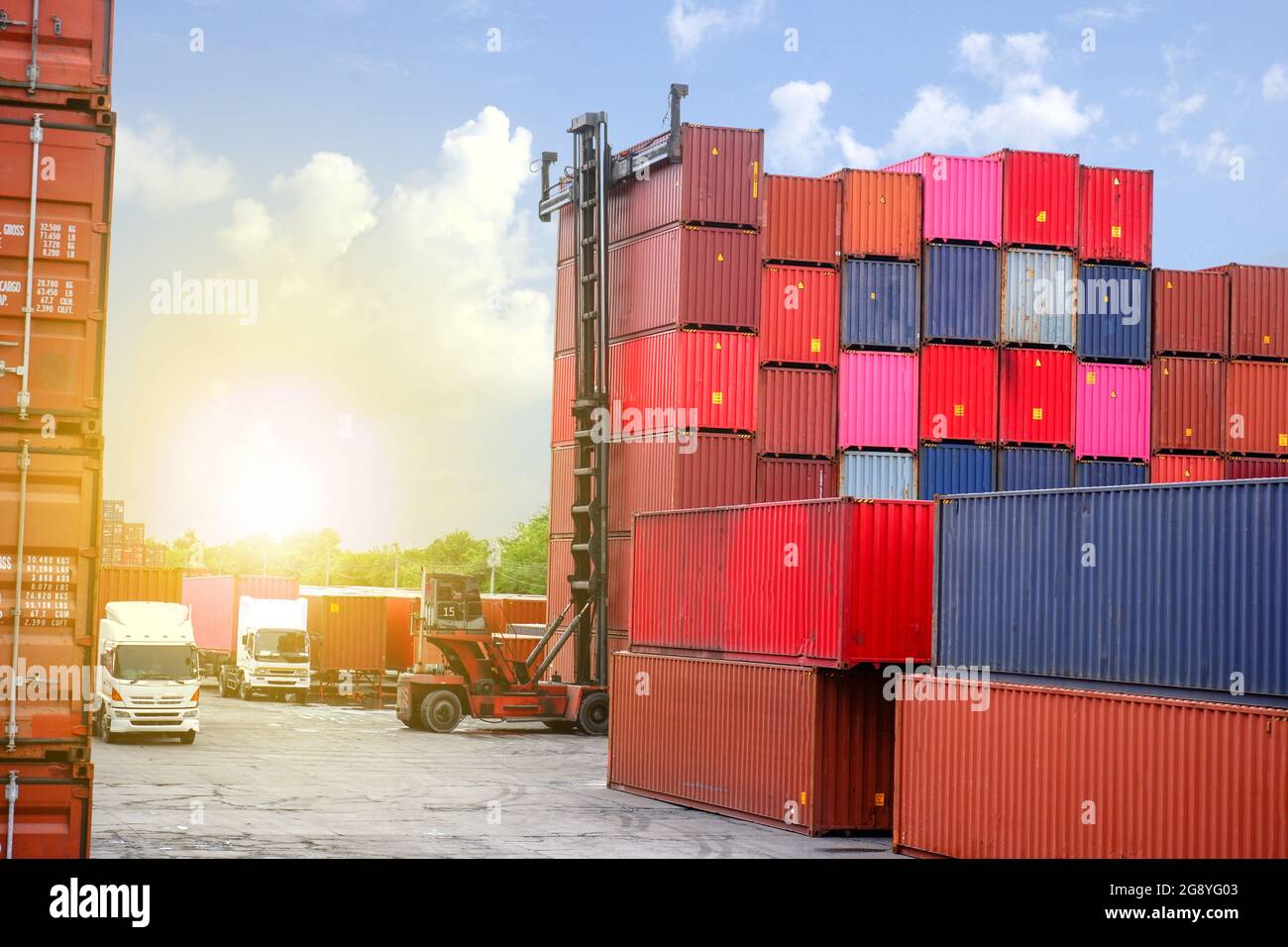 Forklift truck lifting cargo container in shipping yard or dock yard ...