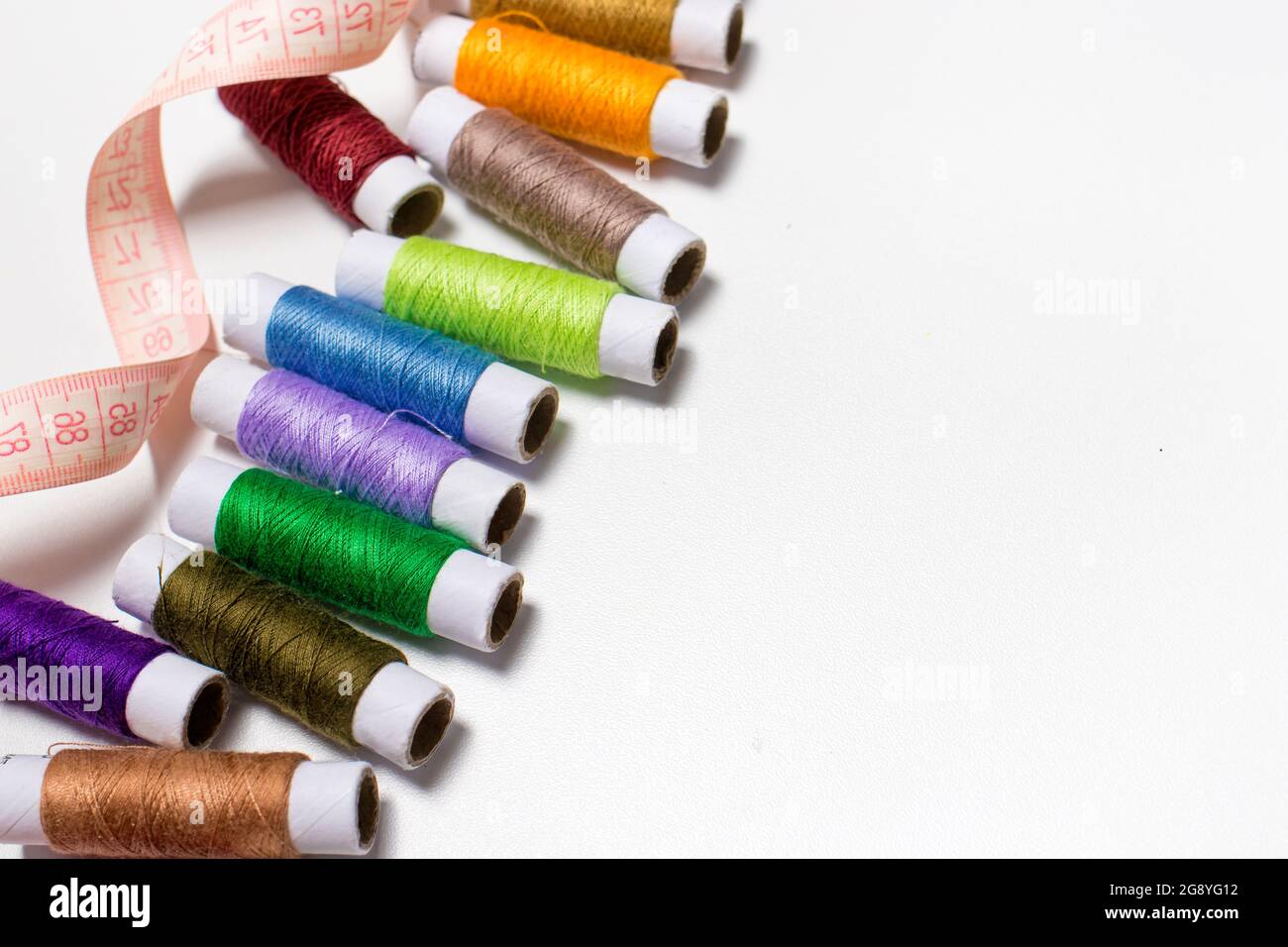 Tape measure and threads on white with space for the text of the banner ...