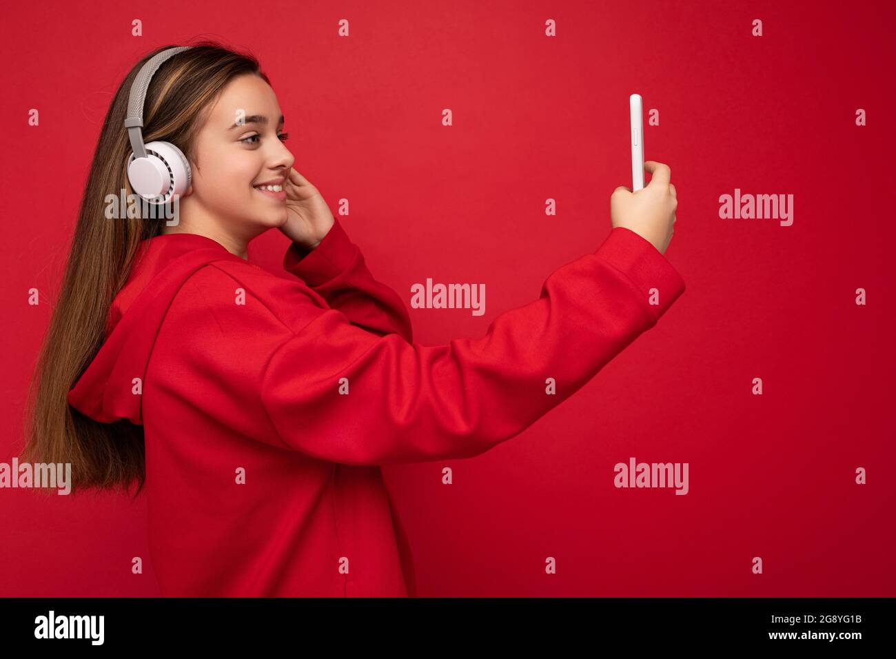 Side-profile Shot of happy smiling pretty brunette girl wearing red ...