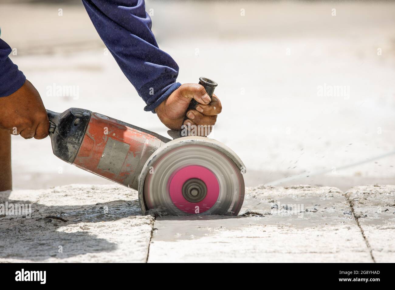 Worker using tool to cut concrete floor Stock Photo - Alamy