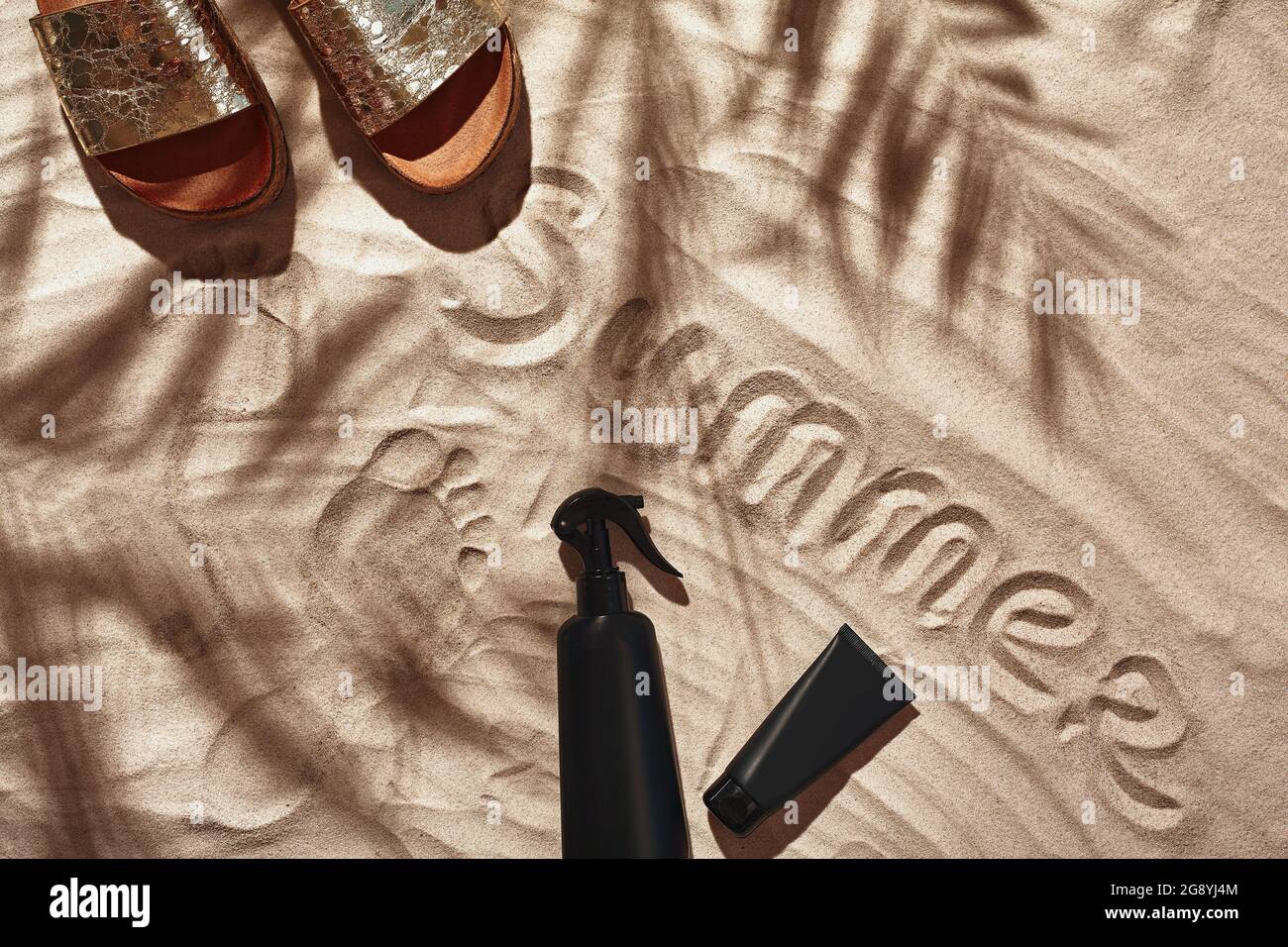 Traveler vacation accessories are laid out on a white beach sand. Flat ...