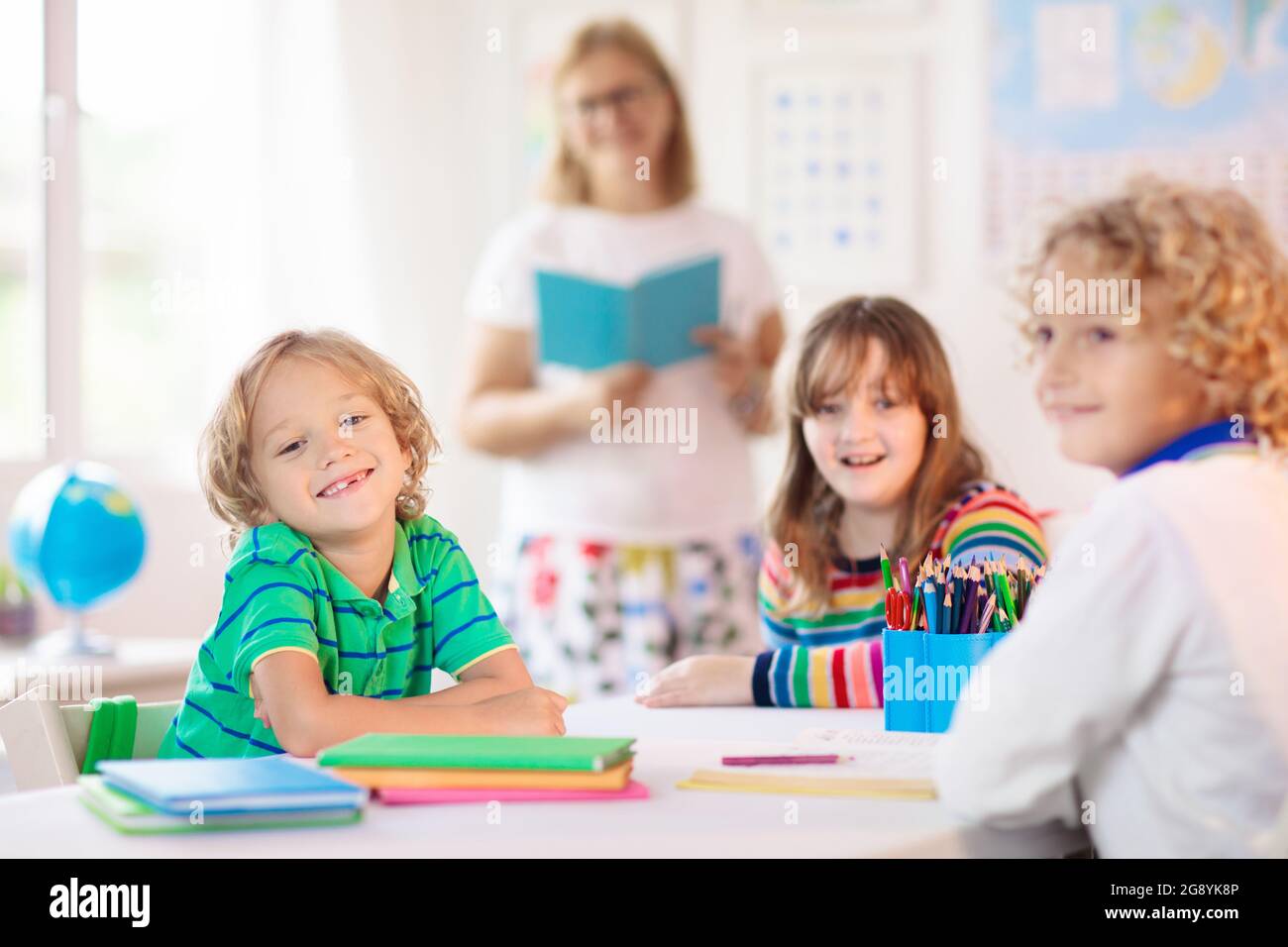 Kids in school. Preschool children in class. Happy kids back to school ...