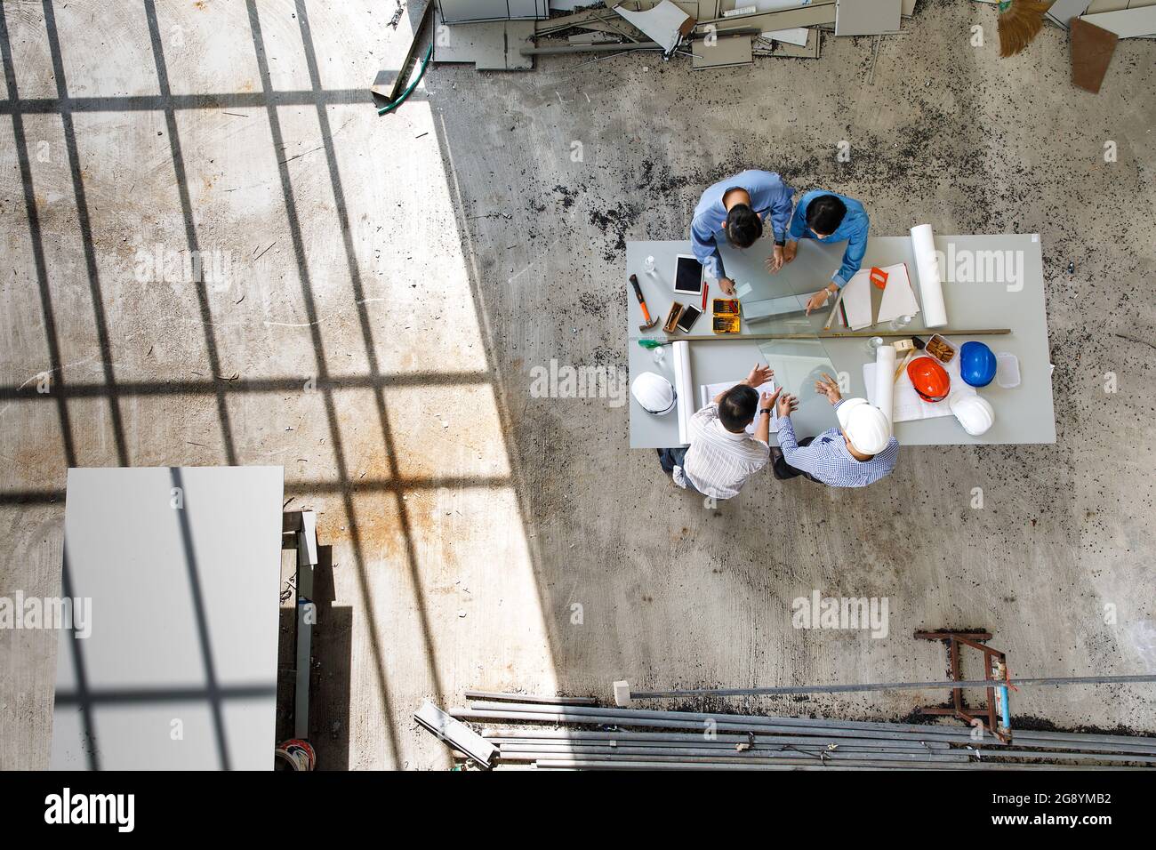Four engineers in team making a discussion at construction site with ...