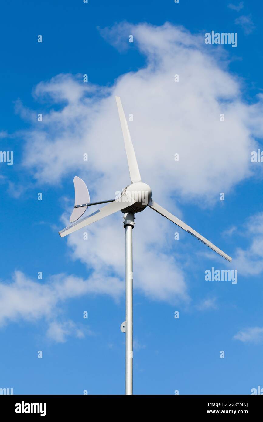 Eco power, wind turbine generating electricity against partly cloudy ...