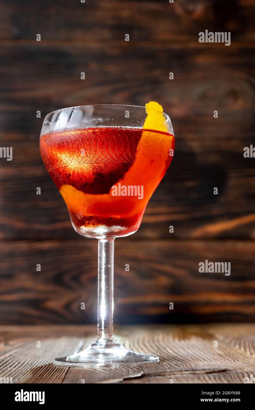 Glass of Boulevardier cocktail on wooen background Stock Photo - Alamy