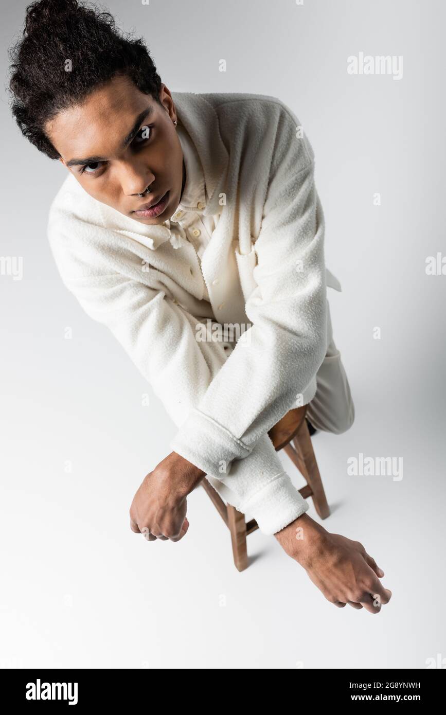 overhead view of trendy african american guy in white clothes looking ...