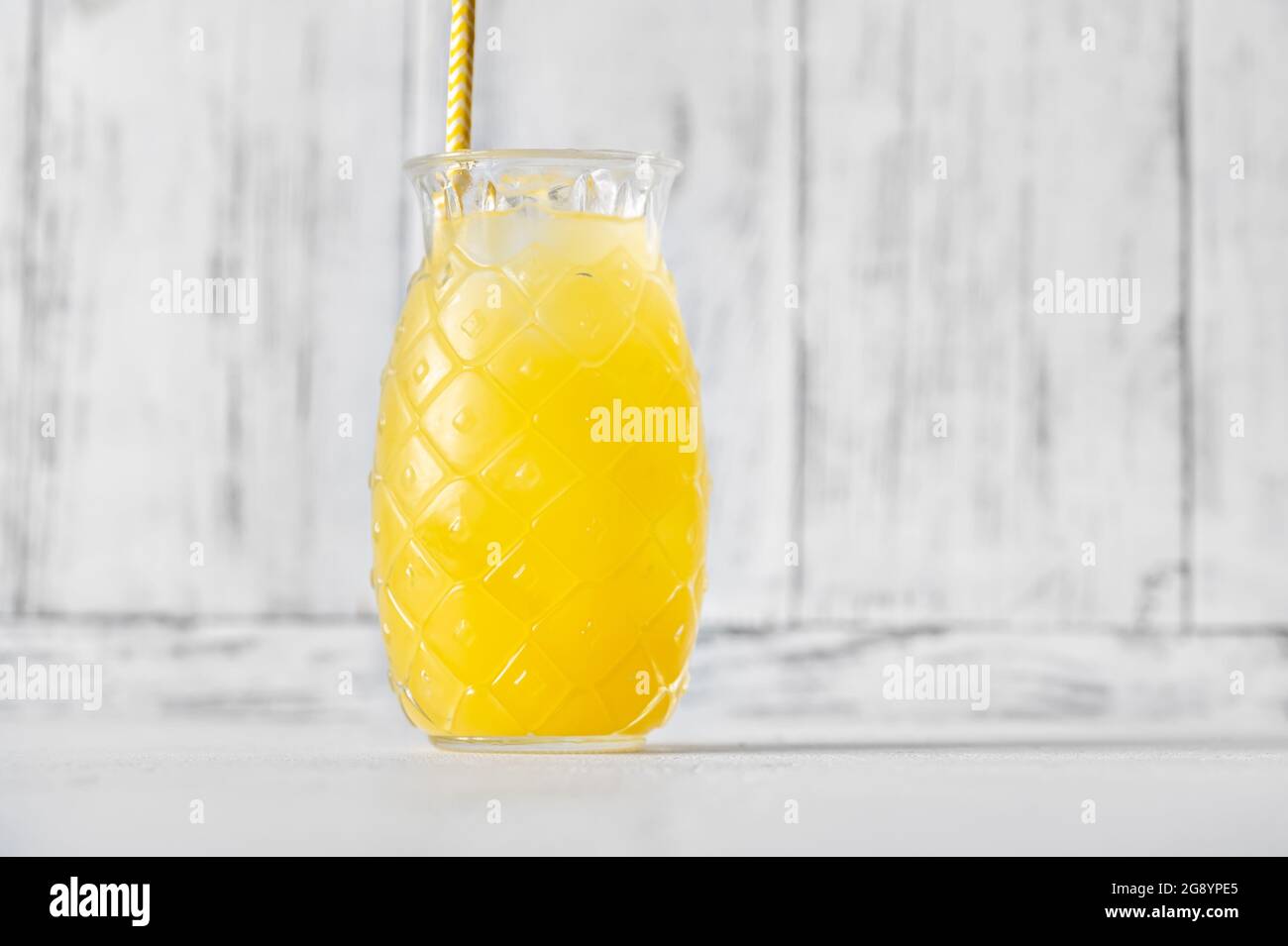 Glass of pineapple tiki style cocktail on white background Stock Photo ...