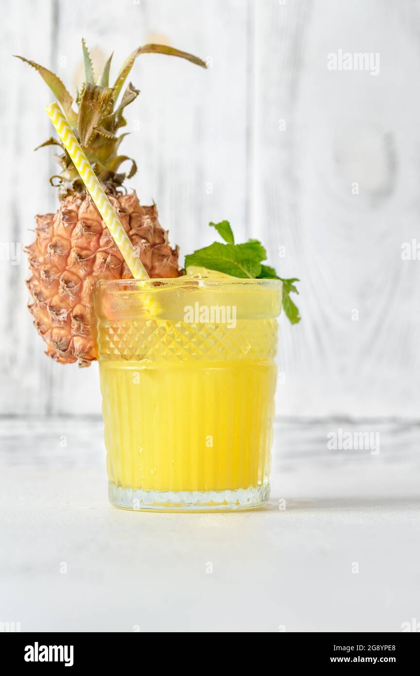 Glass of pineapple tiki style cocktail on white background Stock Photo ...