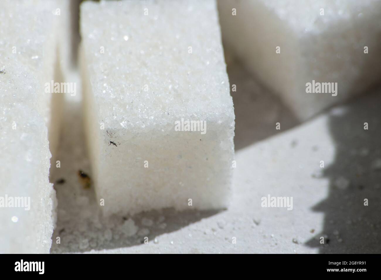 A lump of white sugar. Square sugar. Sweet product Stock Photo - Alamy