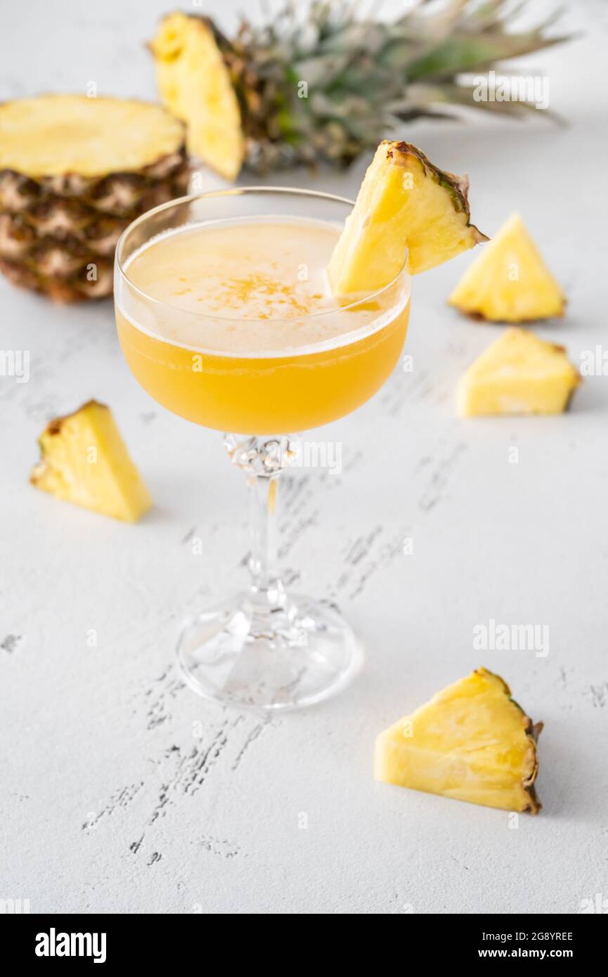 Glass of Algonquin cocktail garnished with pineapple slice Stock Photo ...