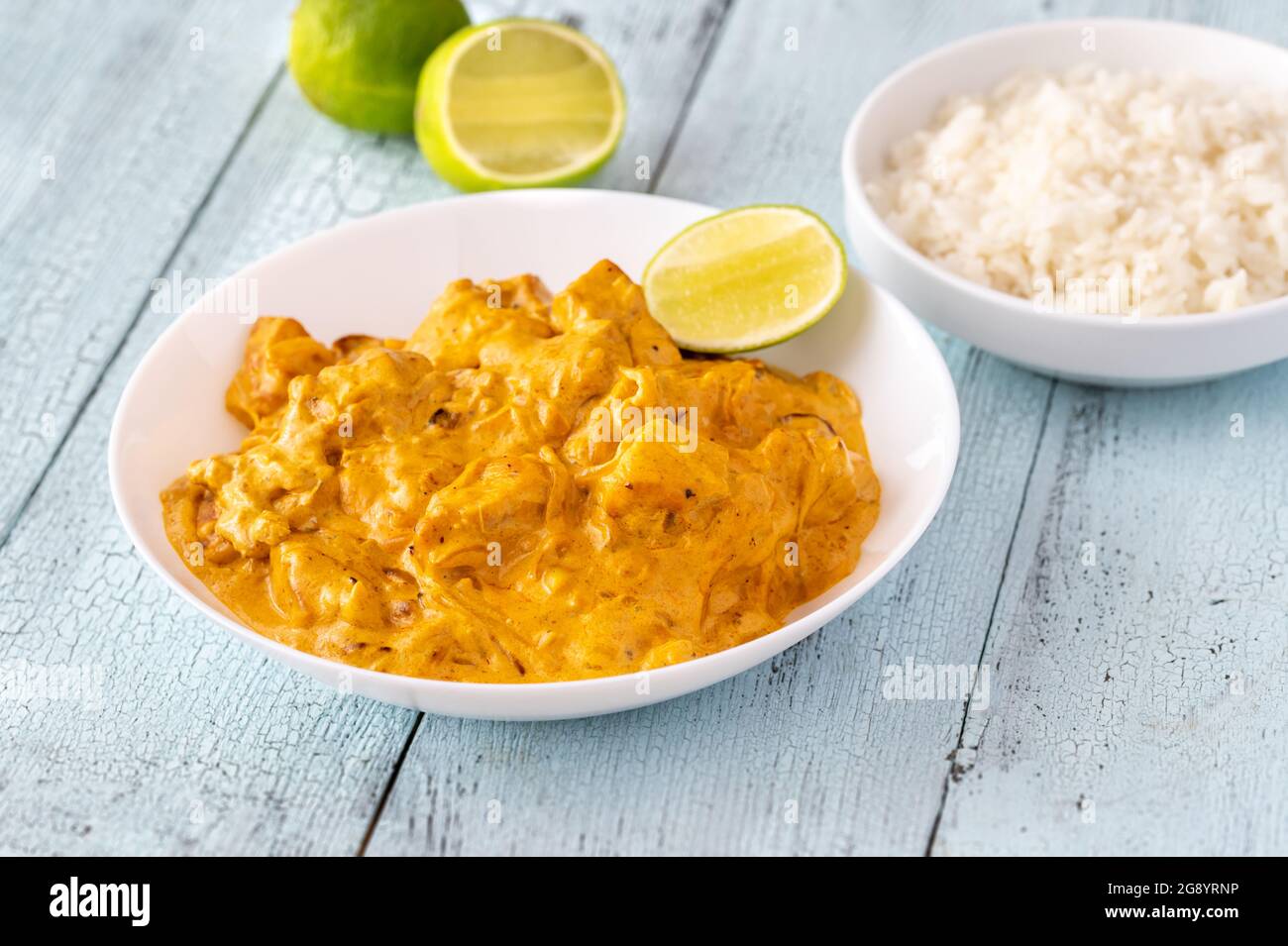 Bowls of chicken curry and cooked white rice Stock Photo - Alamy